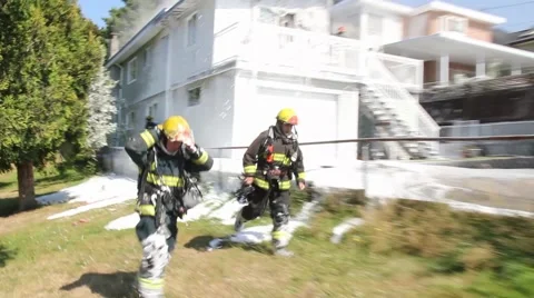 Two firemen running by the camera covere... | Stock Video | Pond5