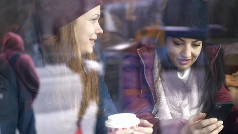 Two friends drink coffee in a cafe with ... | Stock Video | Pond5