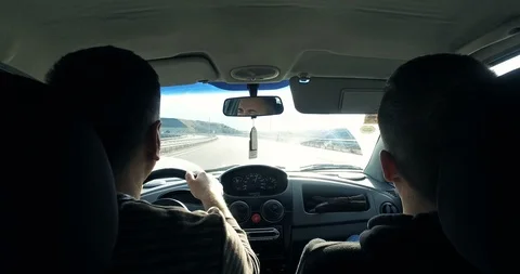 Two friends drive in small car on highwa... | Stock Video | Pond5