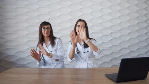 Two funny doctors sitting at the table a... | Stock Video | Pond5