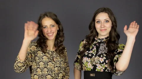 Two girl waving hand saying hello and hi... | Stock Video | Pond5