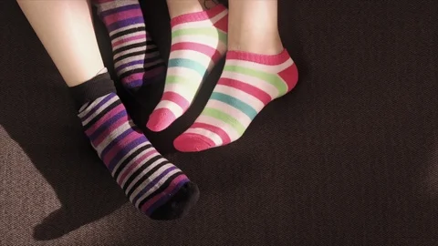 Two Girls in Colorful Socks Touch Each O... | Stock Video | Pond5
