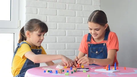 Two girls at home playing board games wh... | Stock Video | Pond5