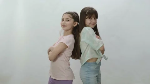 Two girls lean against each other in iso... | Stock Video | Pond5