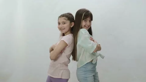 Two girls lean against each other in iso... | Stock Video | Pond5