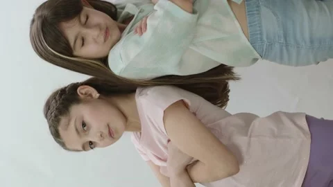 Two girls lean against each other in iso... | Stock Video | Pond5