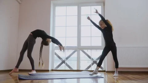 Two girls makes a bridge poses showing t... | Stock Video | Pond5