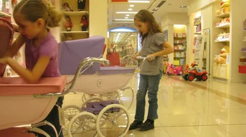 Two girls play with toy carriages for do... | Stock Video | Pond5