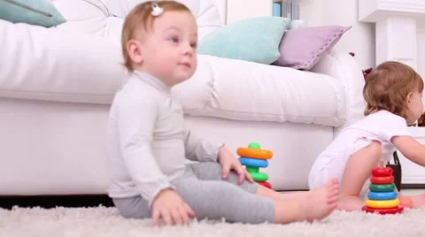 Two girls sit and play with pyramids and... | Stock Video | Pond5