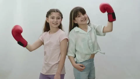 Two girls standing side by side isolated... | Stock Video | Pond5