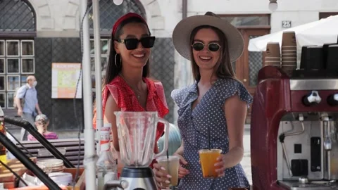 Two girls taking lemonade and smiling on... | Stock Video | Pond5
