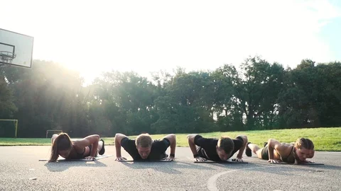 two girls two boys doing 6 count burpees | Stock Video | Pond5