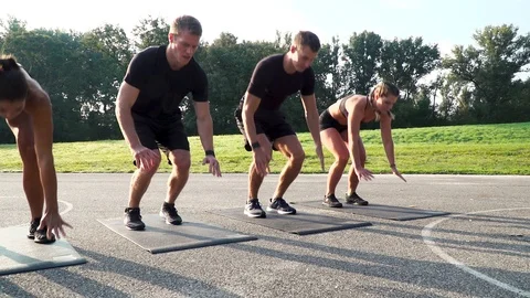 two girls two boys doing 6 count burpees | Stock Video | Pond5