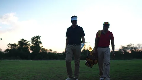 Two golfers are talking on the training ... | Stock Video | Pond5