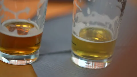 Two half empty draft beers at restaurant... | Stock Video | Pond5