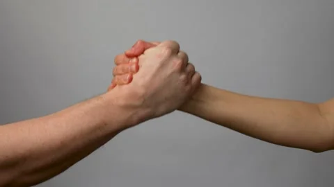 Two hands handshake on gray background. | Stock Video | Pond5
