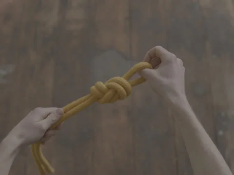 Two Hands Tying a Figure Eight Loop Knot... | Stock Video | Pond5