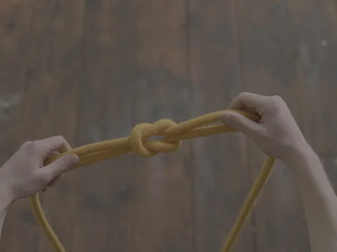 Two Hands Tying a Running Knot Photograp... | Stock Video | Pond5