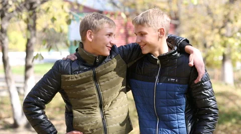 Two handsome twin brothers talking to ea... | Stock Video | Pond5