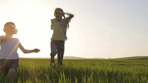 Two happy children playing in the field ... | Stock Video | Pond5