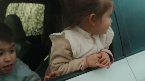 Two happy children sticking their heads ... | Stock Video | Pond5