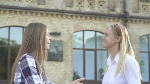 Two happy girlfriends glad to meet each ... | Stock Video | Pond5