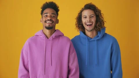 Two happy guys laughing isolated over or... | Stock Video | Pond5