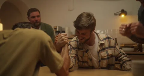 Two happy guys play arm wrestling while ... | Stock Video | Pond5