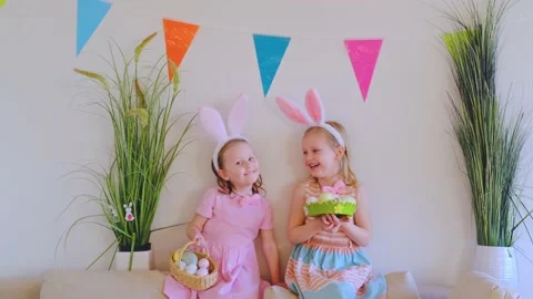 Two happy little girls sisters in rabbit... | Stock Video | Pond5
