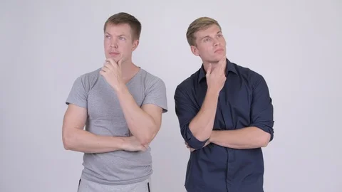 Two happy young handsome men thinking to... | Stock Video | Pond5
