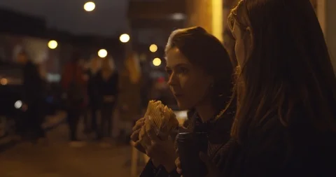 Two hungry girls eating fast food snack ... | Stock Video | Pond5