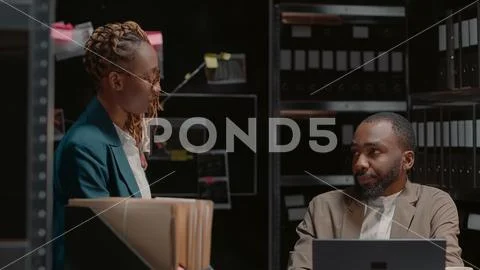 Two investigators studying forensic evidence on wall map ~ Premium ...