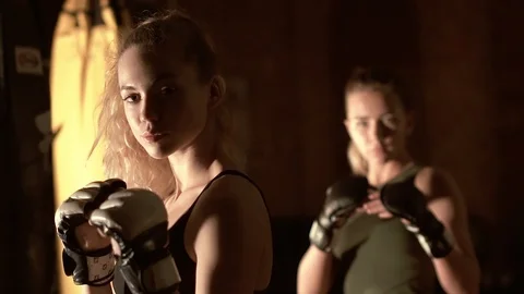 Two kickboxer girls are posing in front ... | Stock Video | Pond5