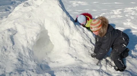 Two kids boy and girl play on snow pile ... | Stock Video | Pond5