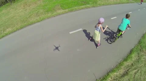 Two kids boy with little girl ride on ro... | Stock Video | Pond5