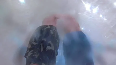 Two kids getting water dumped on them at... | Stock Video | Pond5