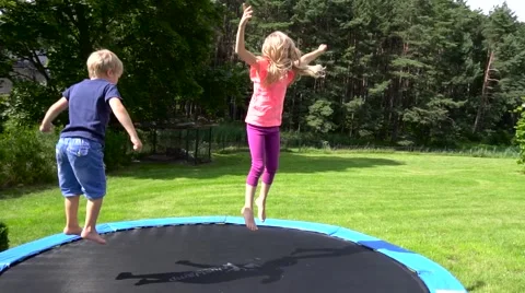 two kids jumping on trampoline | Stock Video | Pond5