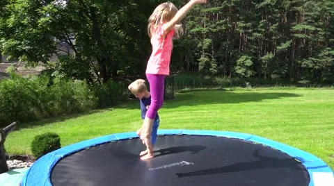 two kids jumping on trampoline | Stock Video | Pond5