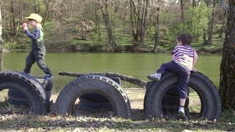 Two kids playing together, jumping and c... | Stock Video | Pond5