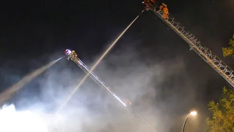 Two ladders fighting structure fire | Stock Video | Pond5