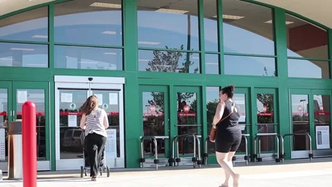 Two ladies walk in to a Target retail st... | Stock Video | Pond5
