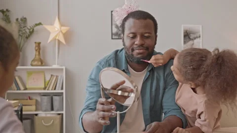 Two Little Girls Applying Make Up on Dad... | Stock Video | Pond5
