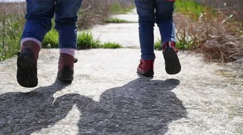 Two little kid girls legs in jeans walki... | Stock Video | Pond5
