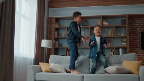 Two little kids boys jumping together on... | Stock Video | Pond5