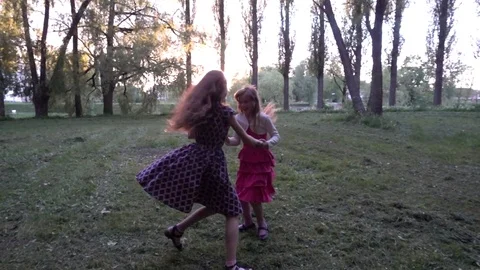 Two little sisters whirled in circle dan... | Stock Video | Pond5
