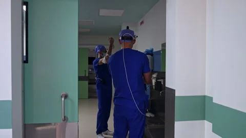 Two male doctors in blue uniforms stands... | Stock Video | Pond5