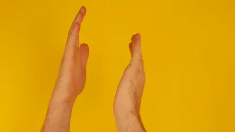 two male hands clapping on a yellow back... | Stock Video | Pond5