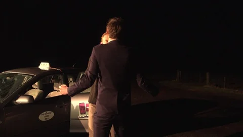 Two men arguing at night outside a taxi | Stock Video | Pond5