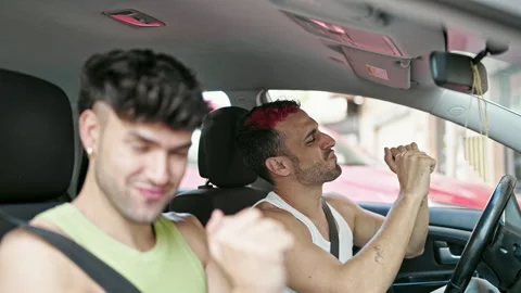 Two men couple sitting on car dancing at... | Stock Video | Pond5