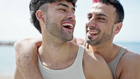 Two men couple smiling confident hugging... | Stock Video | Pond5
